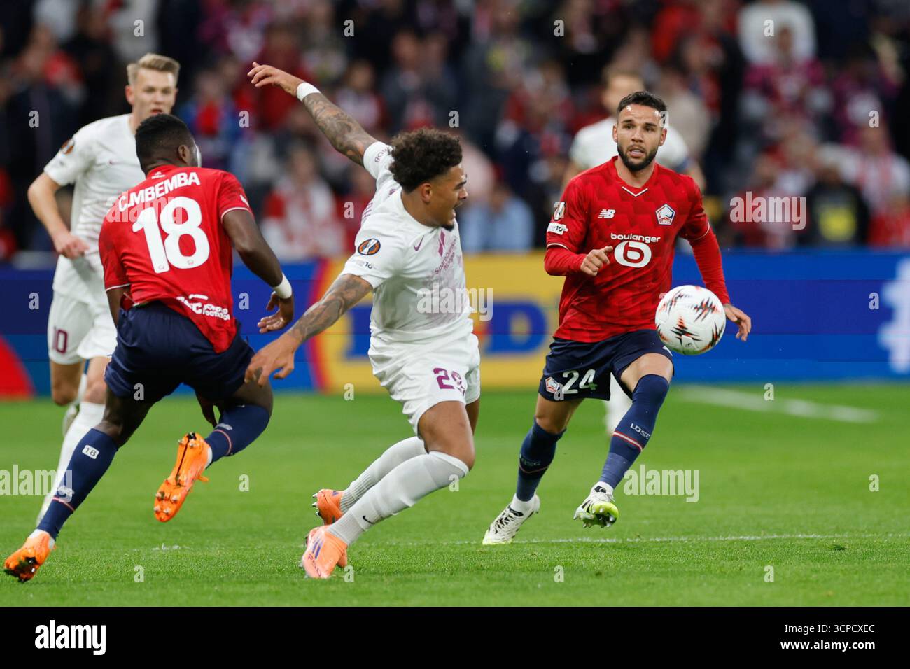 Brann's Noah Holm, center, fights for the ball with Lille's Calvin ...