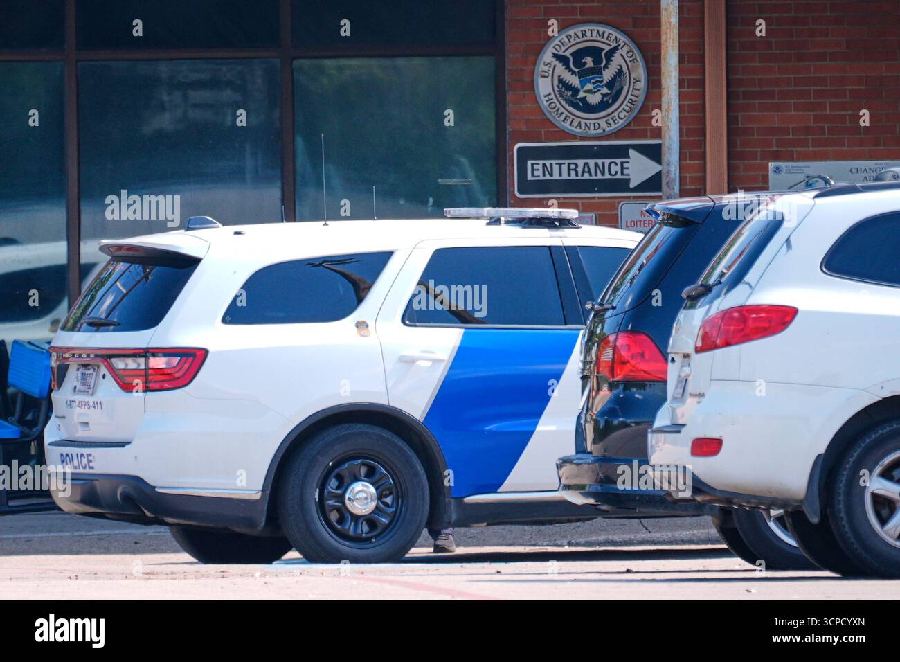A Homeland Security sign is shown at the rear entrance of a U.S ...