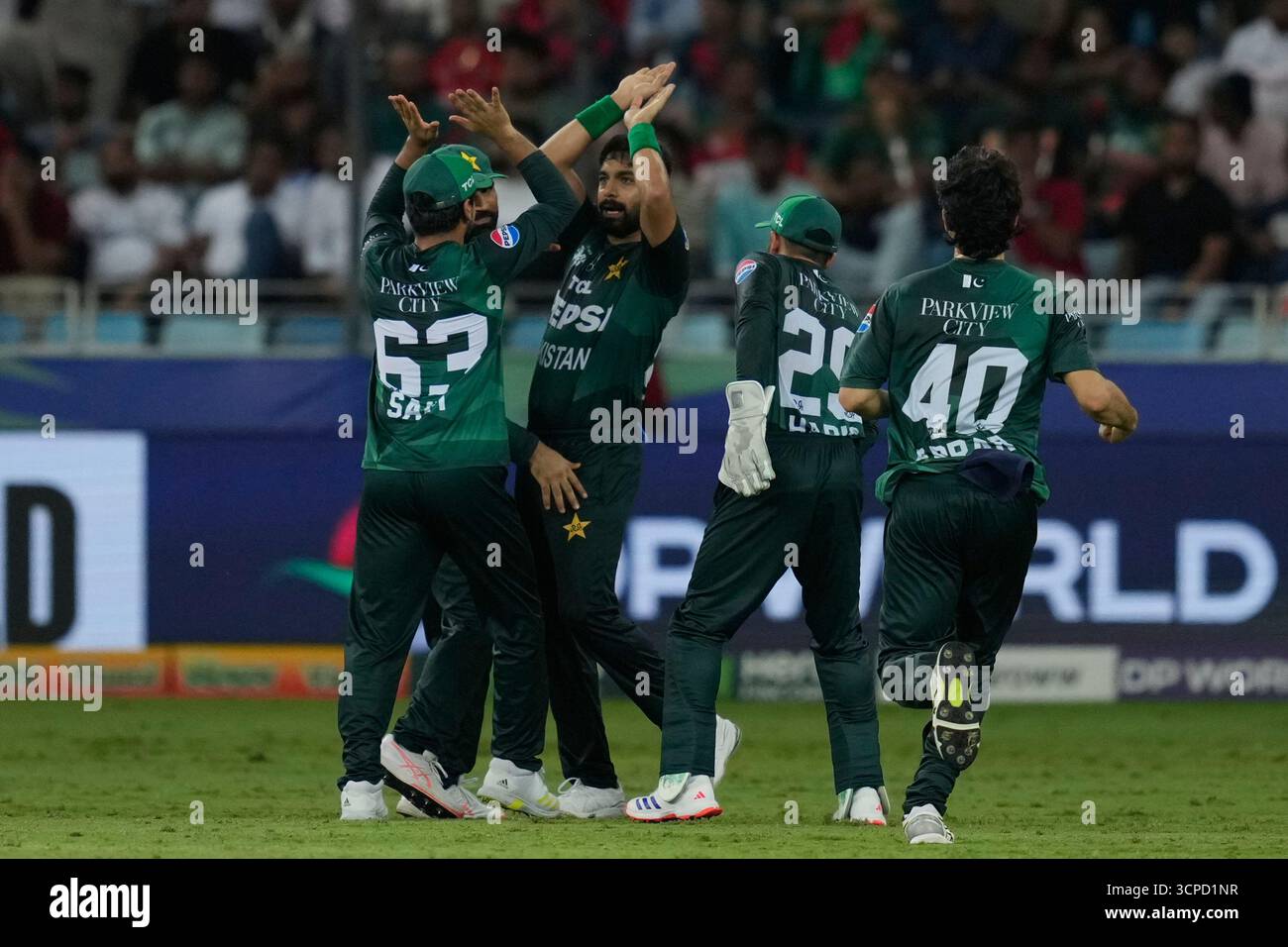 Pakistan's Haris Rauf, center, celebrates with teammates after the ...