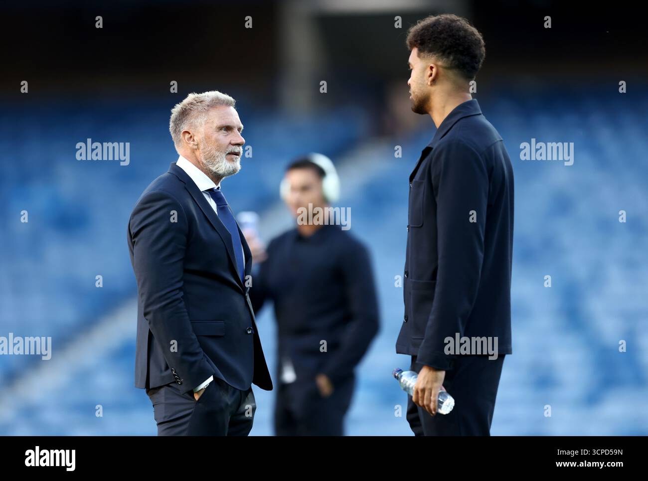 Genk manager Thorsten Fink (left) speaks with Tobias Lawal on the pitch ...