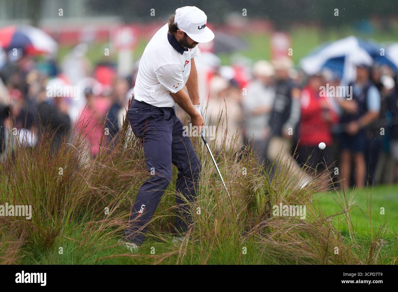 United States' Cameron Young hits from the rough on the 16th hole ...