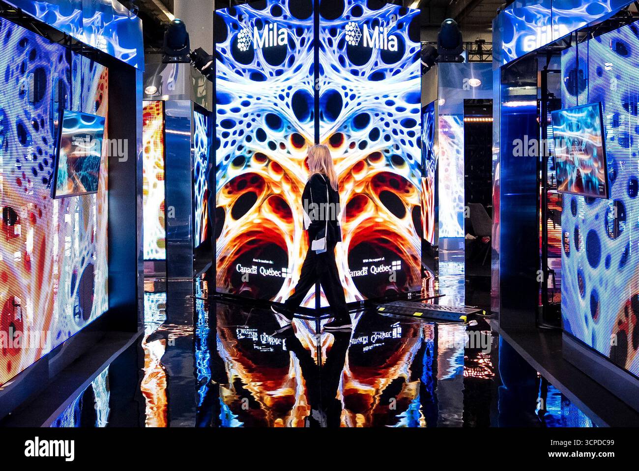 People walk through the Mila, Quebec Artificial Intelligence Institute ...