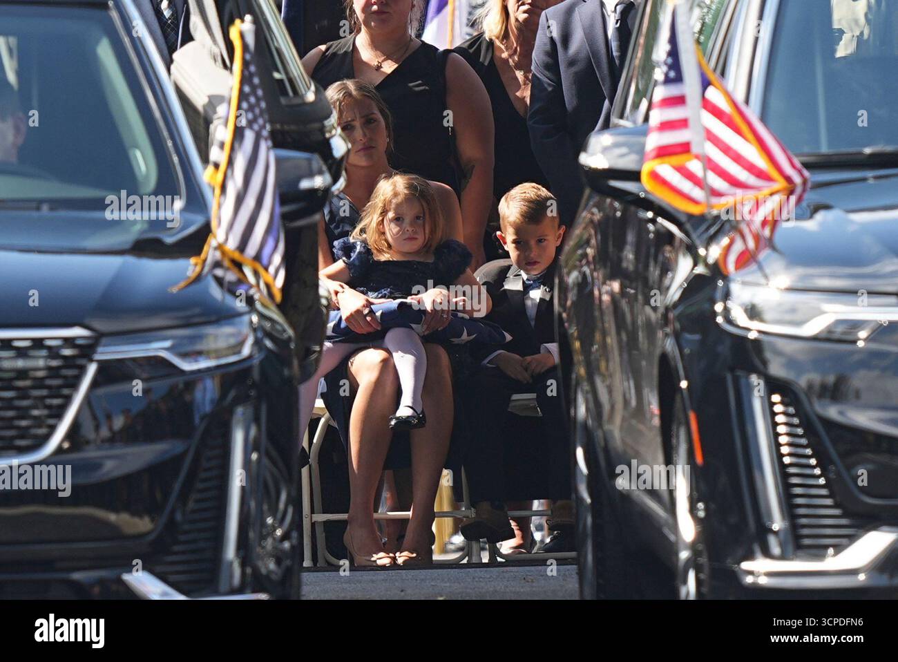 Loved ones look on at the conclusion of funeral services for Northern York County Regional ...