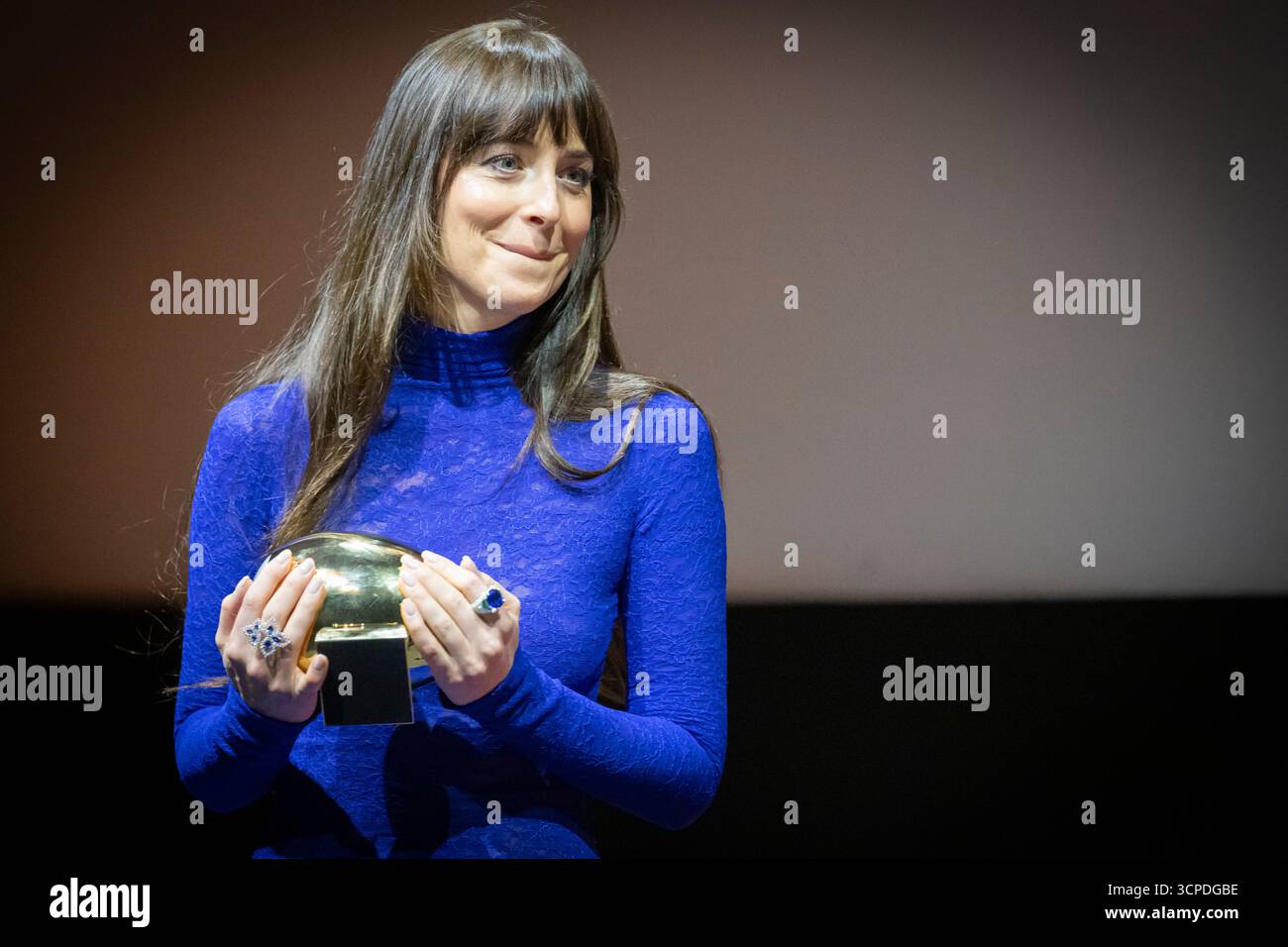 American actress and film producer Dakota Johnson reacts after receiving the Golden Eye Award at ...
