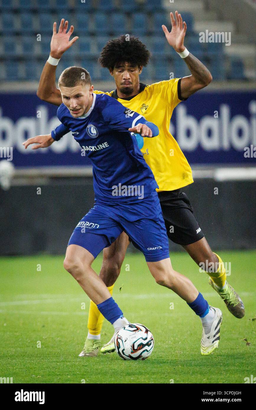 Gent, Belgium. 25th Sep, 2025. Lierse's Bryan Adinany and Jong Gent's ...