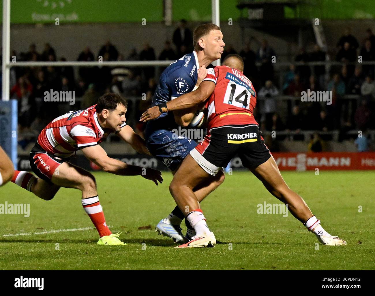 Sale Sharks' Rob du Preez (second right) is tackled by Gloucester's Ben ...