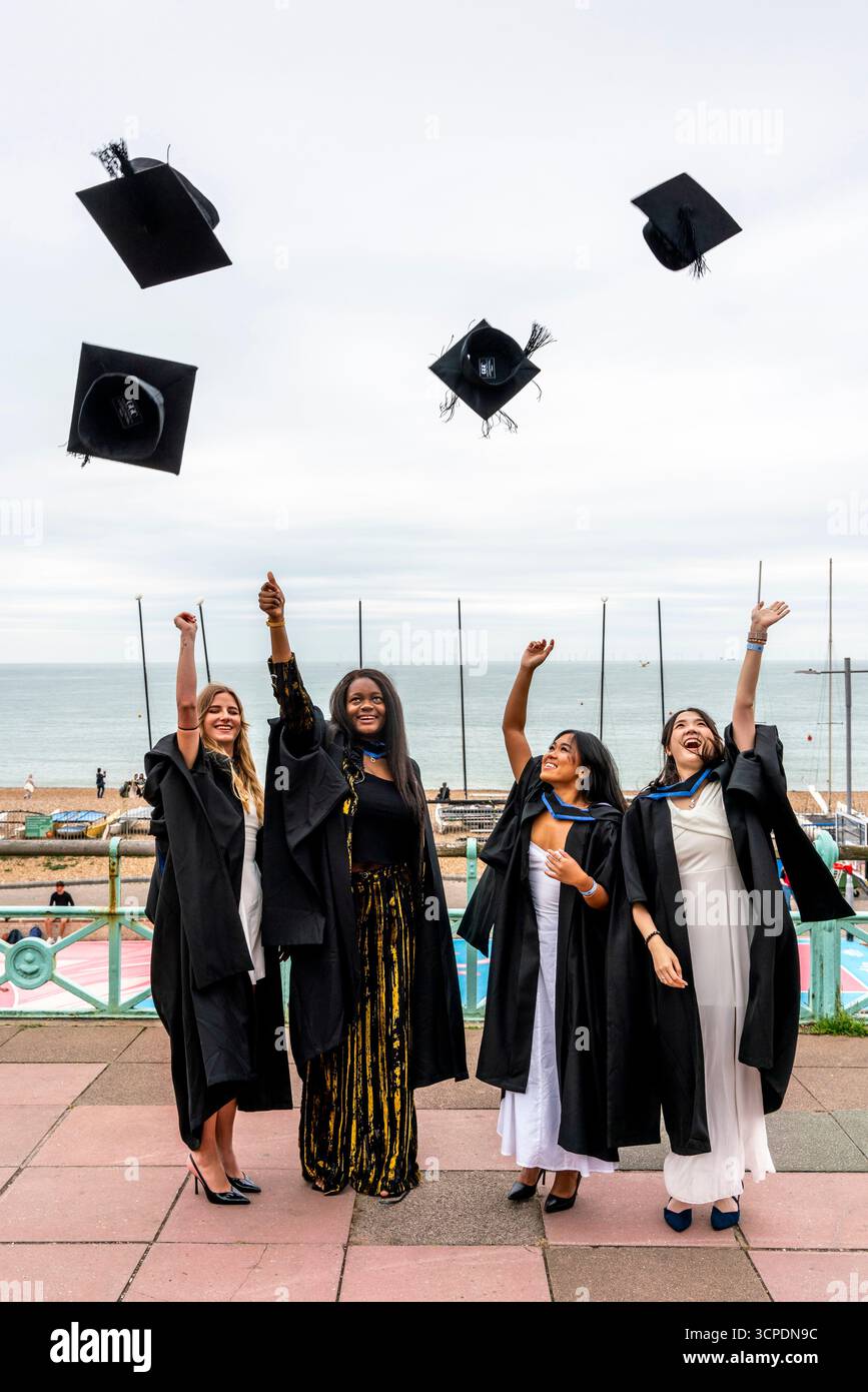 Happy students throwing mortarboards hi-res stock photography and ...
