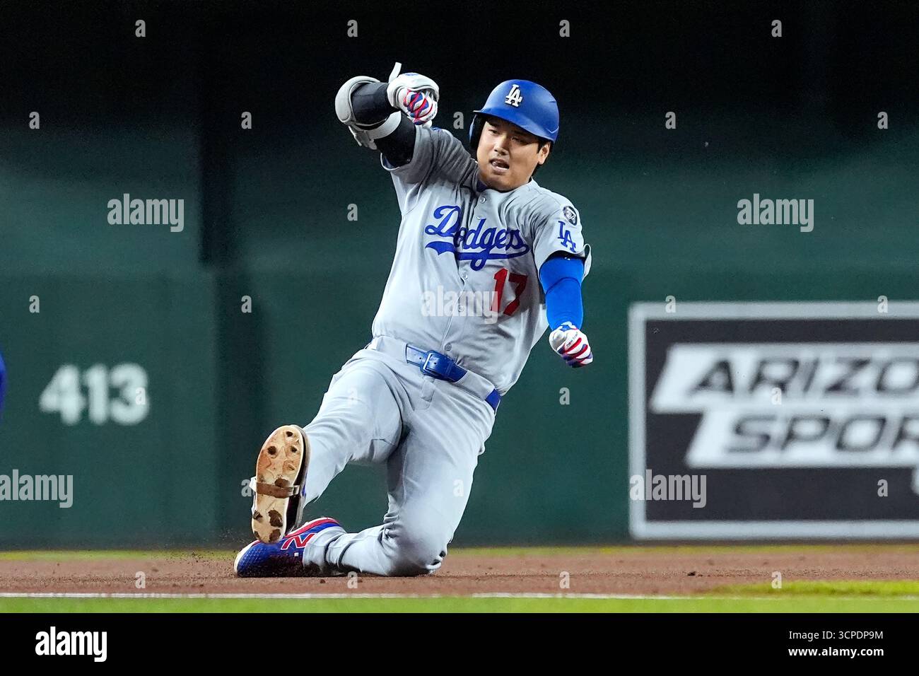 Los Angeles Dodgers' Shohei Ohtani, of Japan, slides into third base ...