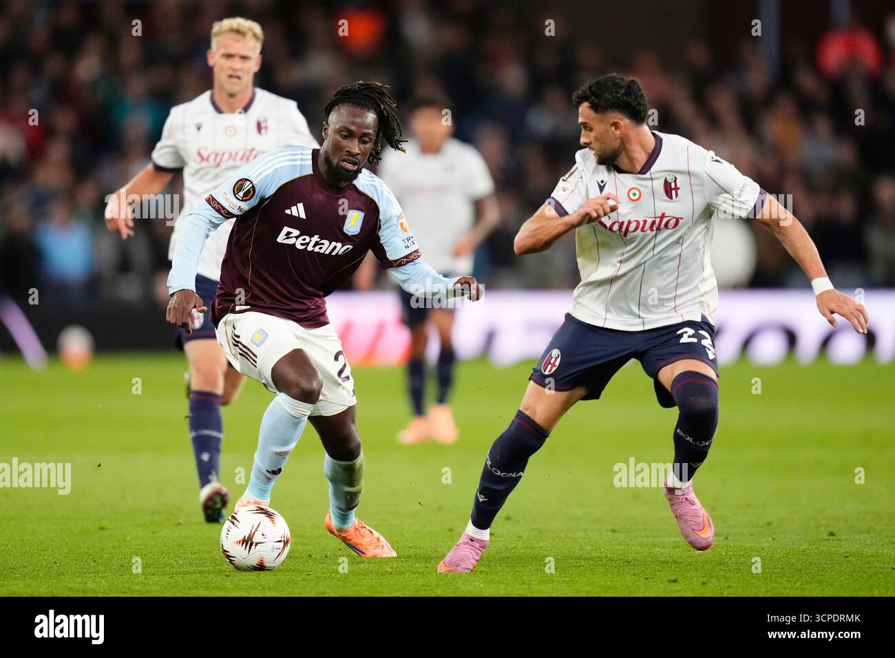 Aston Villa's Evann Guessand (left) and Bologna's Charalambos Lykogiannis battle for the ball ...