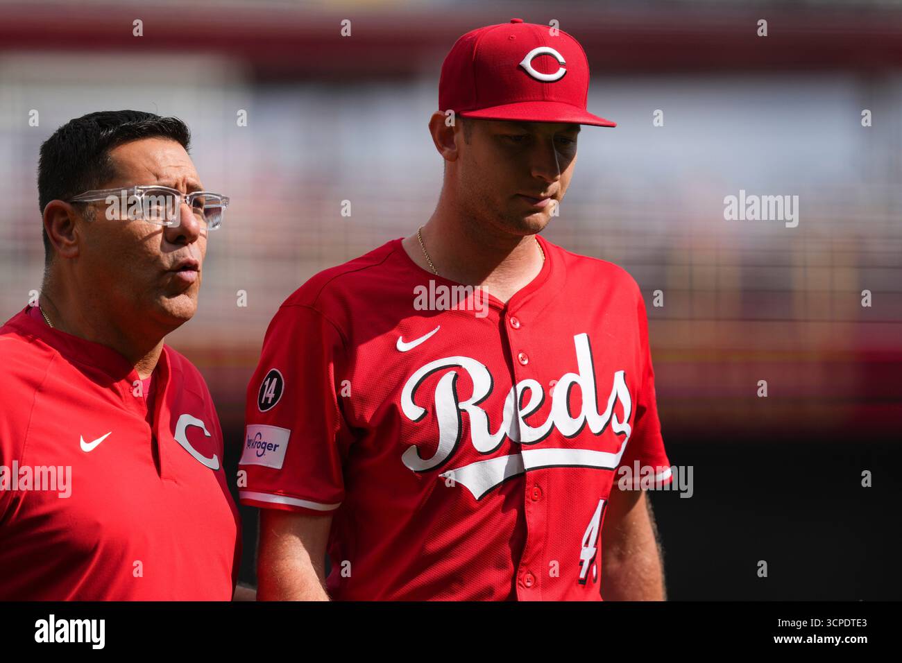 Cincinnati Reds pitcher Nick Lodolo, center, walks to the dugout during ...