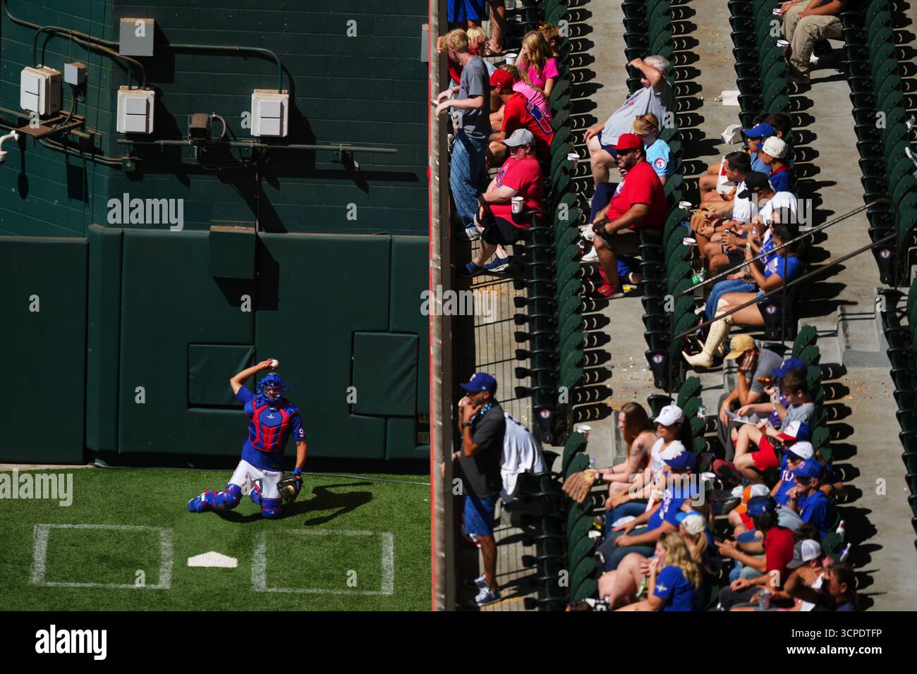 Texas Rangers bullpen catcher Alejandro MartÏnez, left, warms up ...