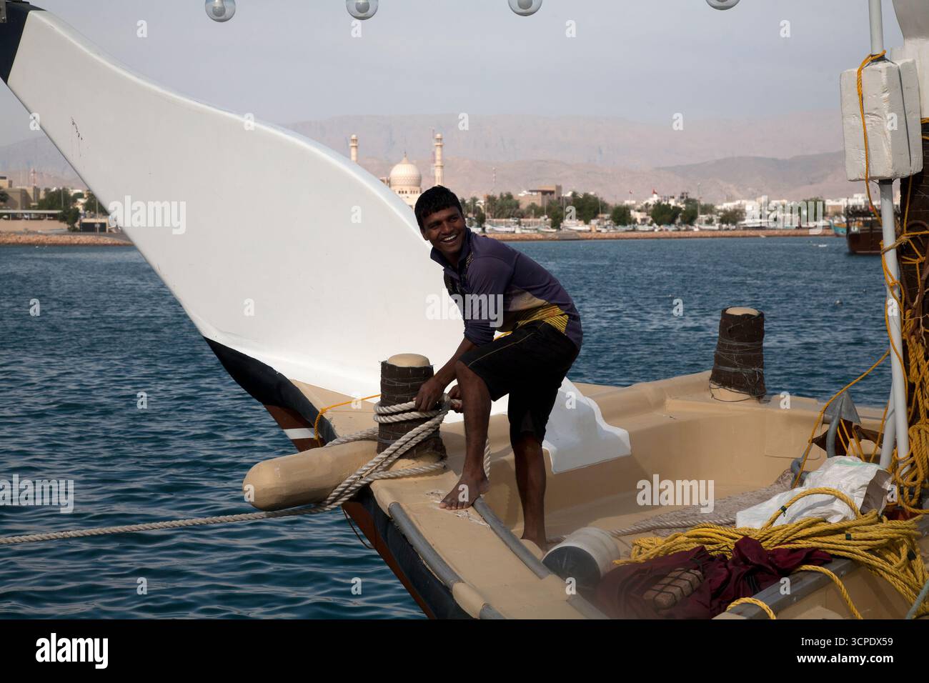 man tying up dhow in sur dhow harbour sur oman sultanate of oman Stock ...