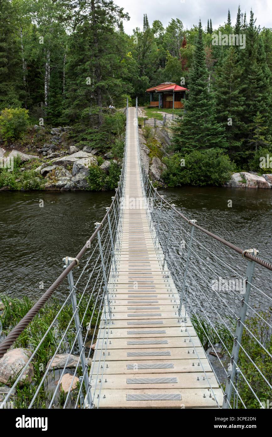The Pinawa Heritage Suspension Bridge crosses the Pinawa river channel ...