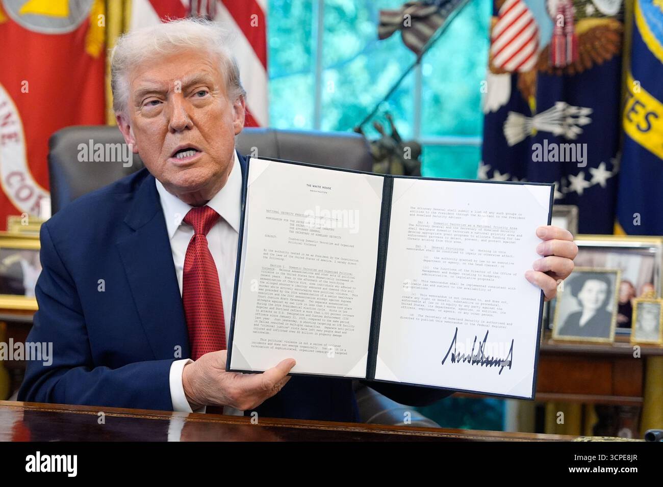 President Donald Trump holds a signed presidential memorandum on ...