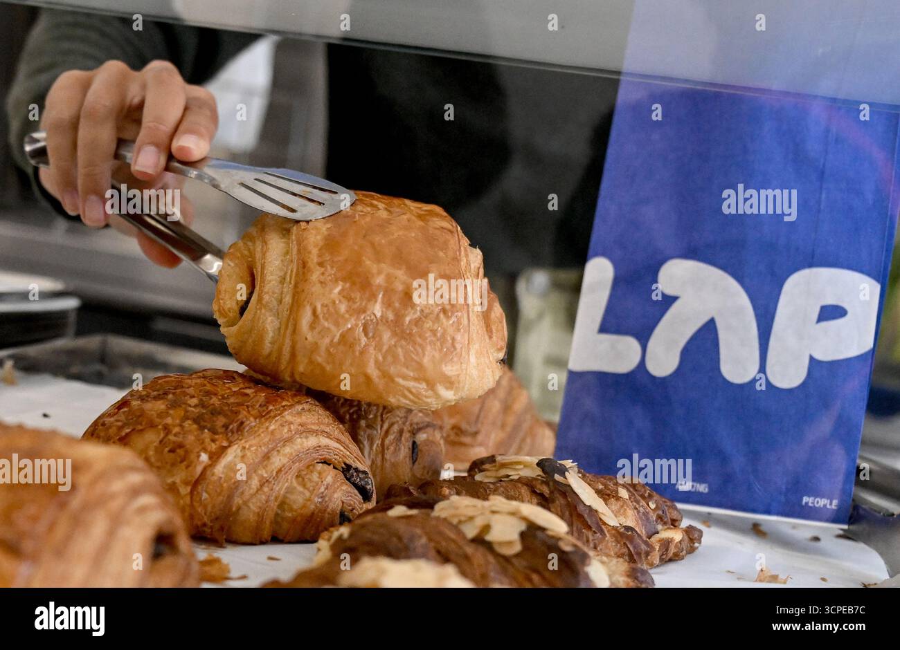 PRODUCTION - 25 September 2025, Berlin: An employee of the LAP coffee ...