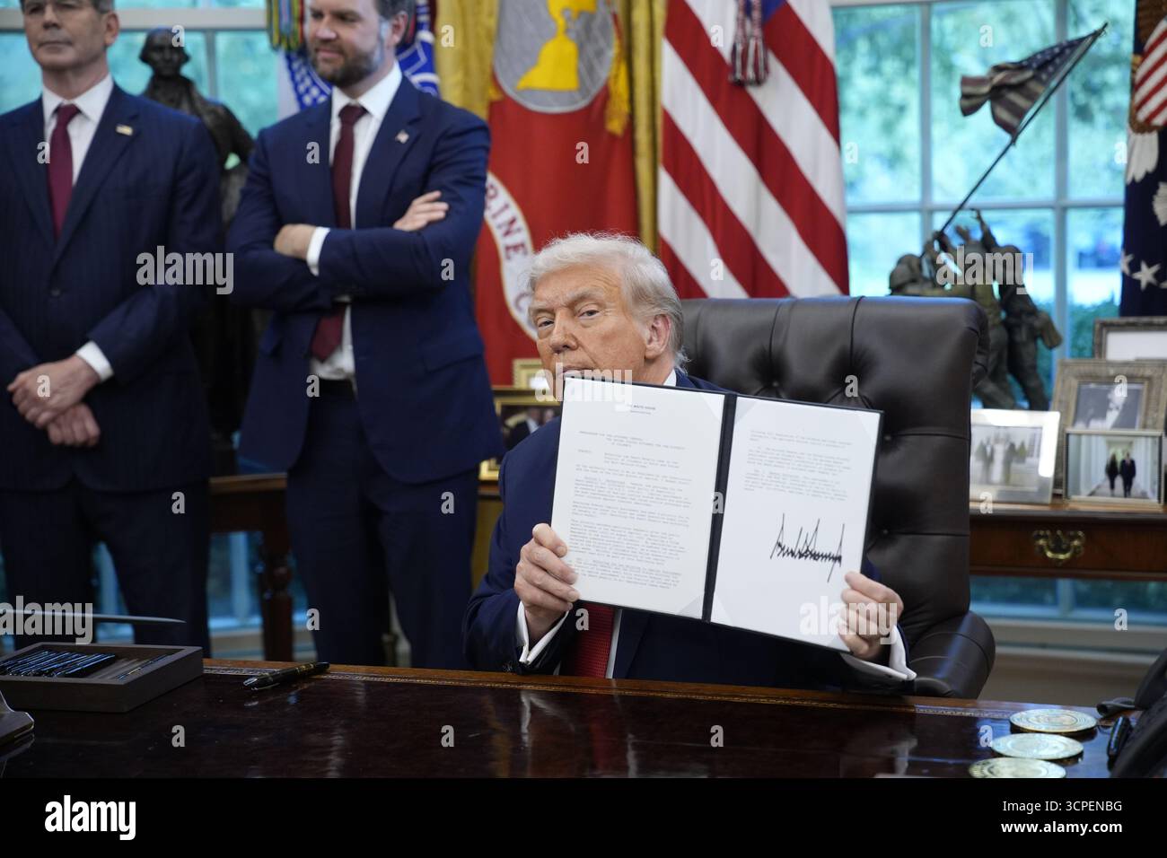 United States President Donald J Trump hold-up a signed executive ...