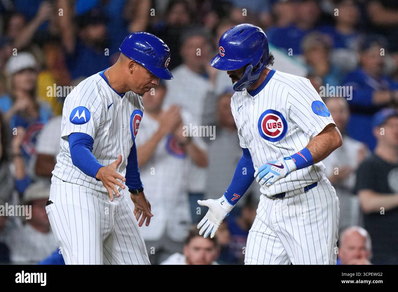 Chicago Cubs' Dansby Swanson, right, celebrates with third base coach ...