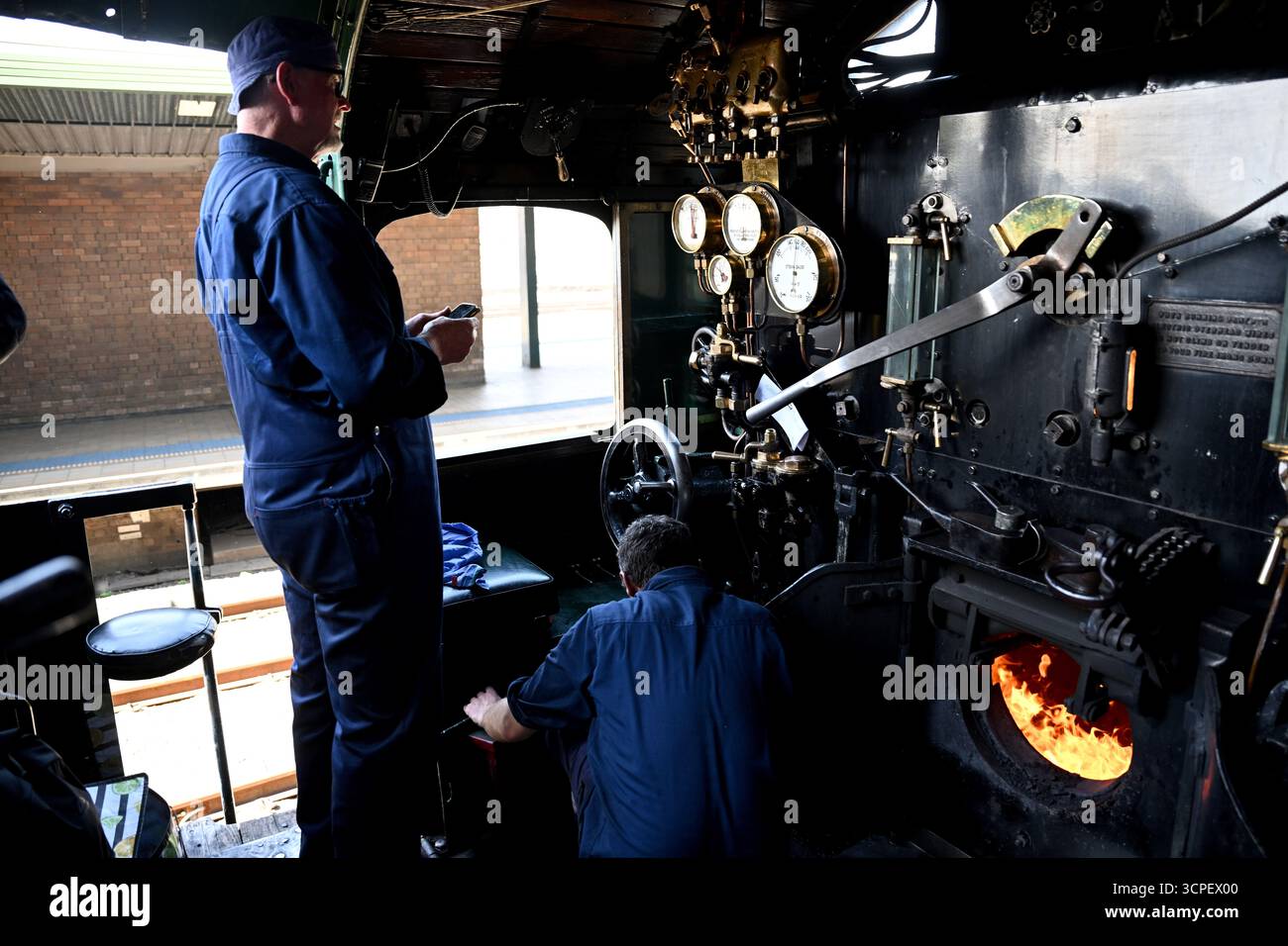 Driver Alex Claassens (left) prepares the 3526 steam locomotive ahead ...