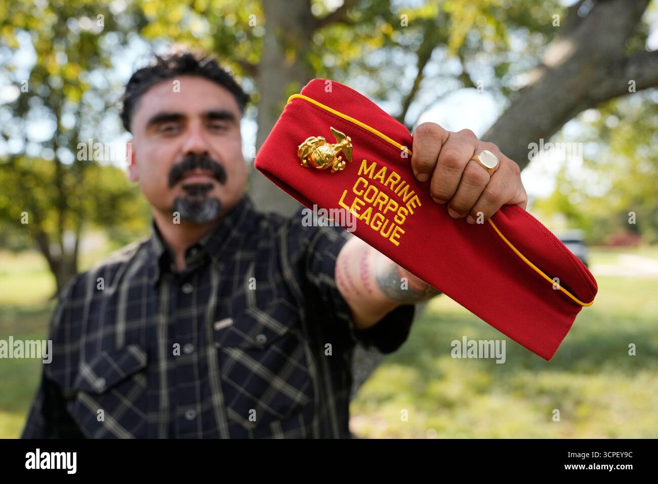 Julio Torres holds his U.S. Marine Corps., veterans cap as he poses for ...