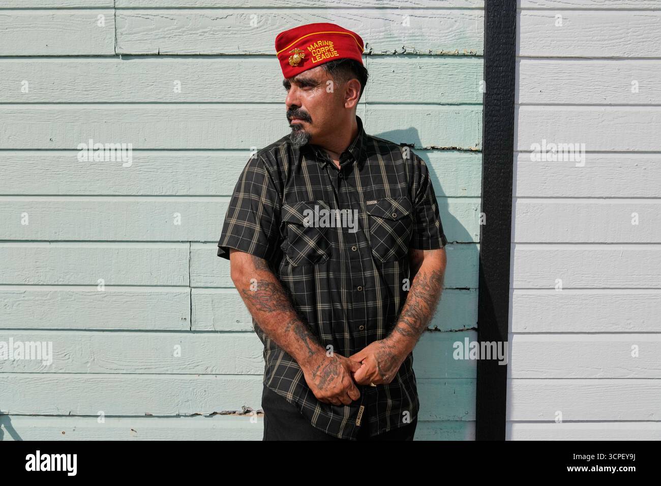 Julio Torres wears his U.S. Marine Corps., veterans cap as he poses for ...