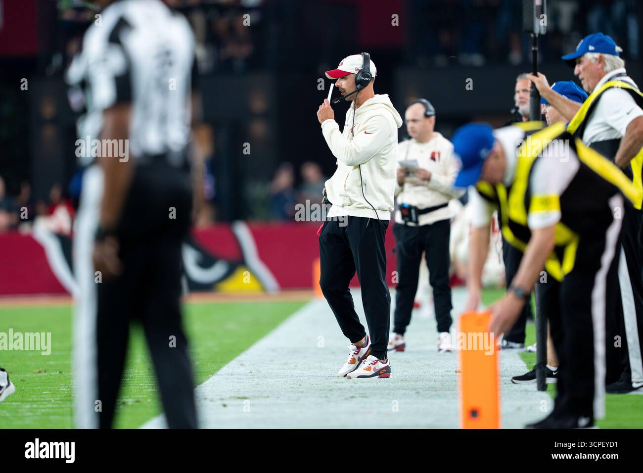 Arizona Cardinals head coach Jonathan Gannon talks into his headset ...