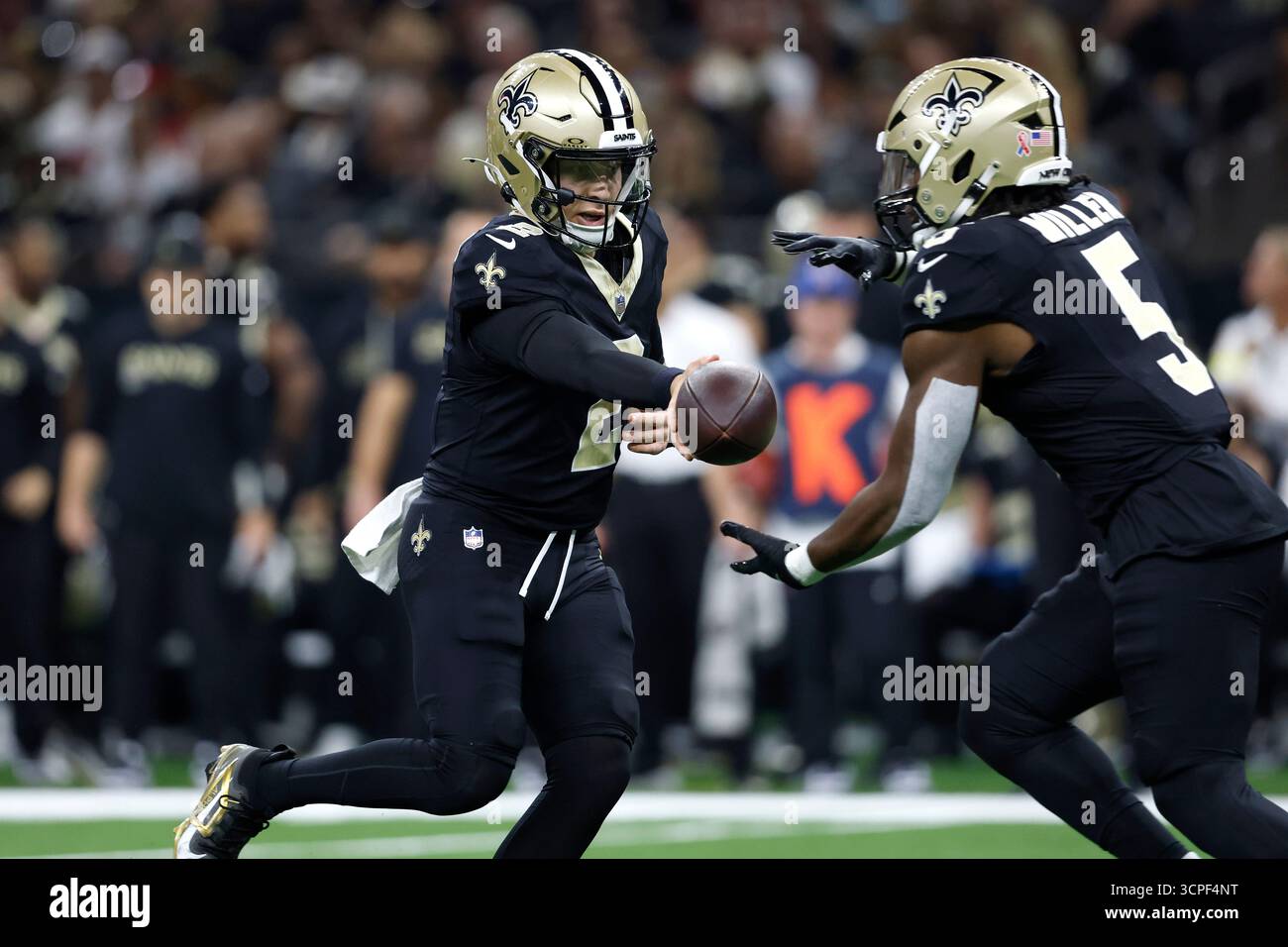New Orleans Saints quarterback Spencer Rattler (2) hands the ball to ...