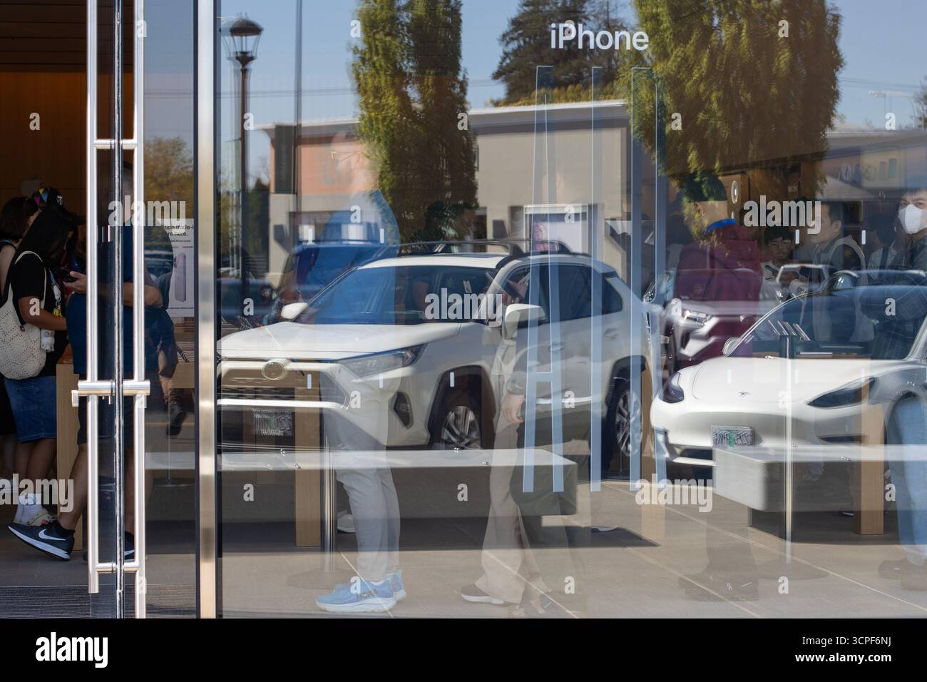 Customers wait in line in an Apple Store in Tigard, Oregon, on Friday ...