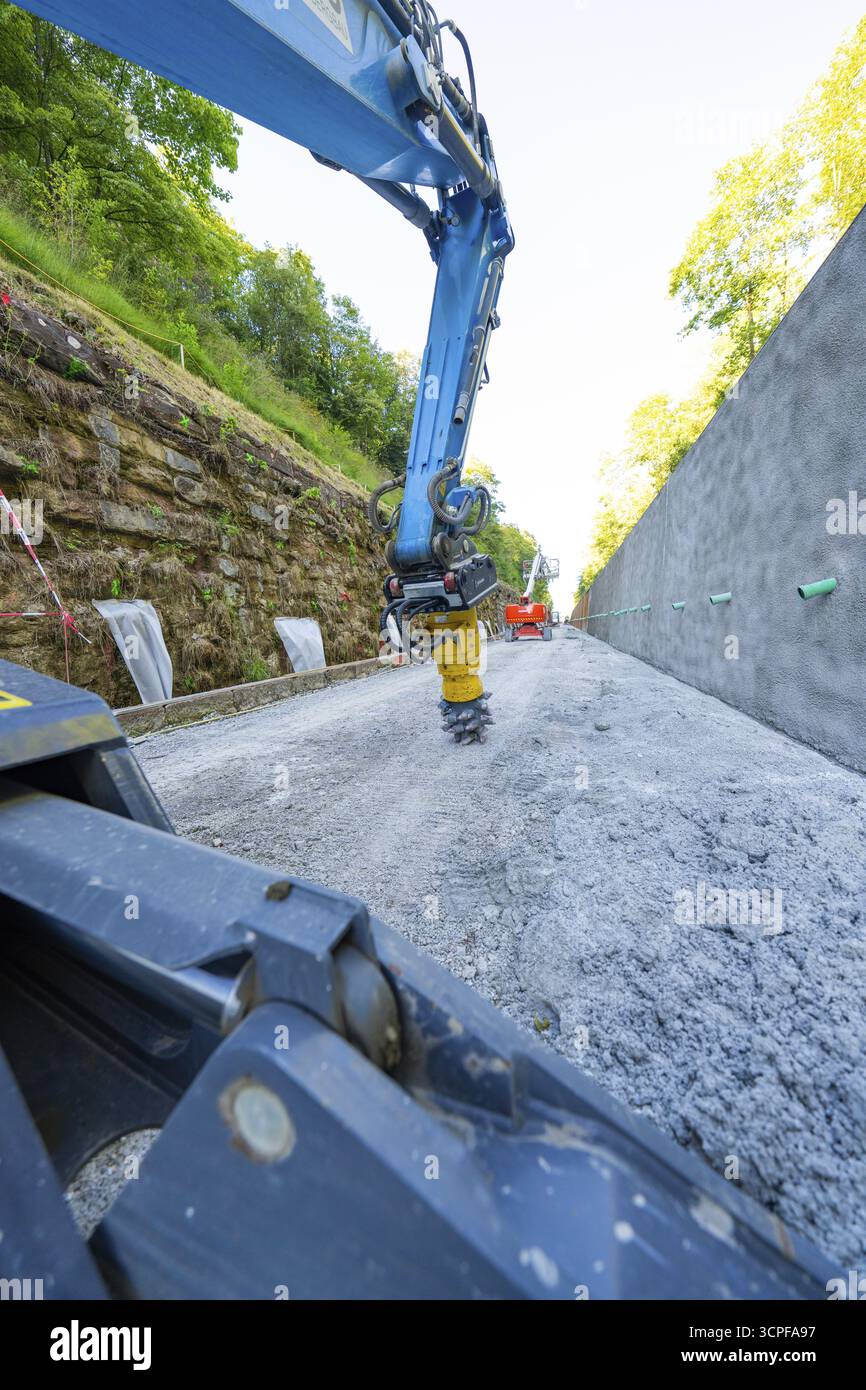 Close-up of crane arm on construction site, surrounded by concrete wall ...