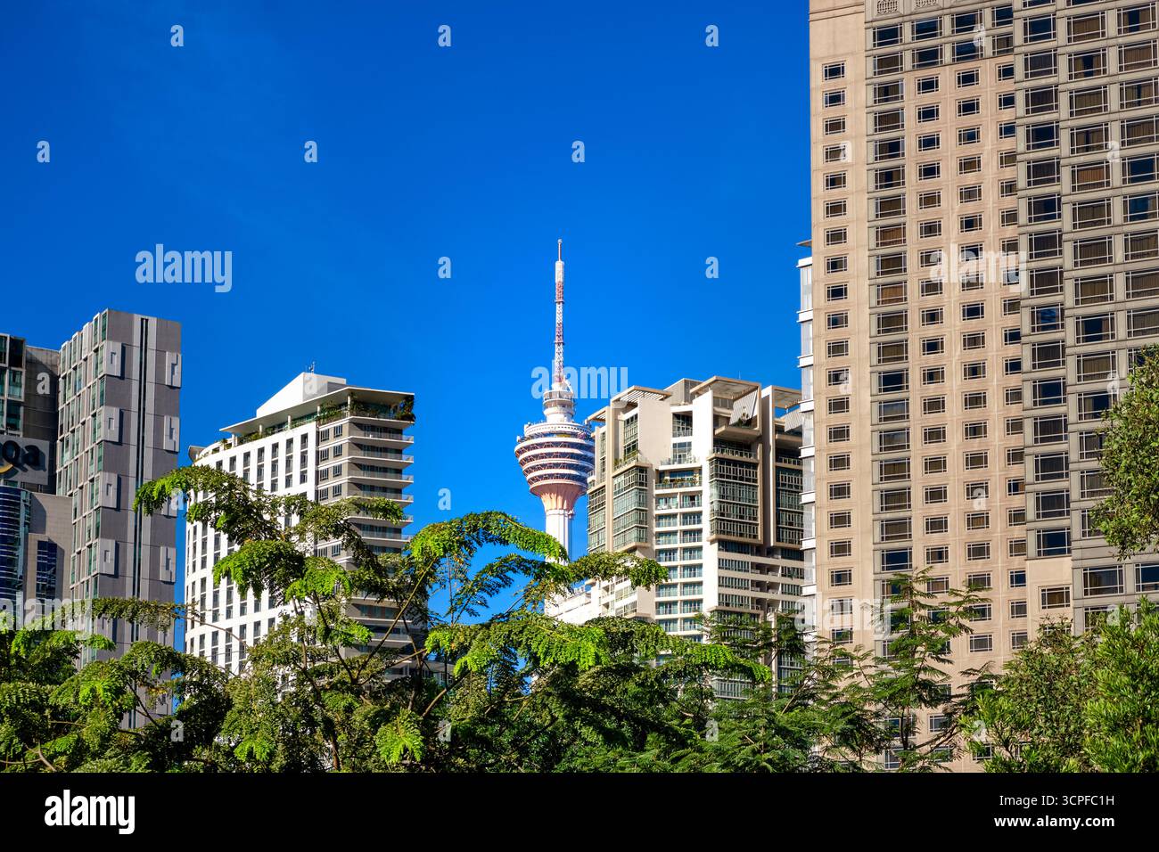 Cityscape view of Kuala Lumpur downtown on sunny day. Menara KL tower ...