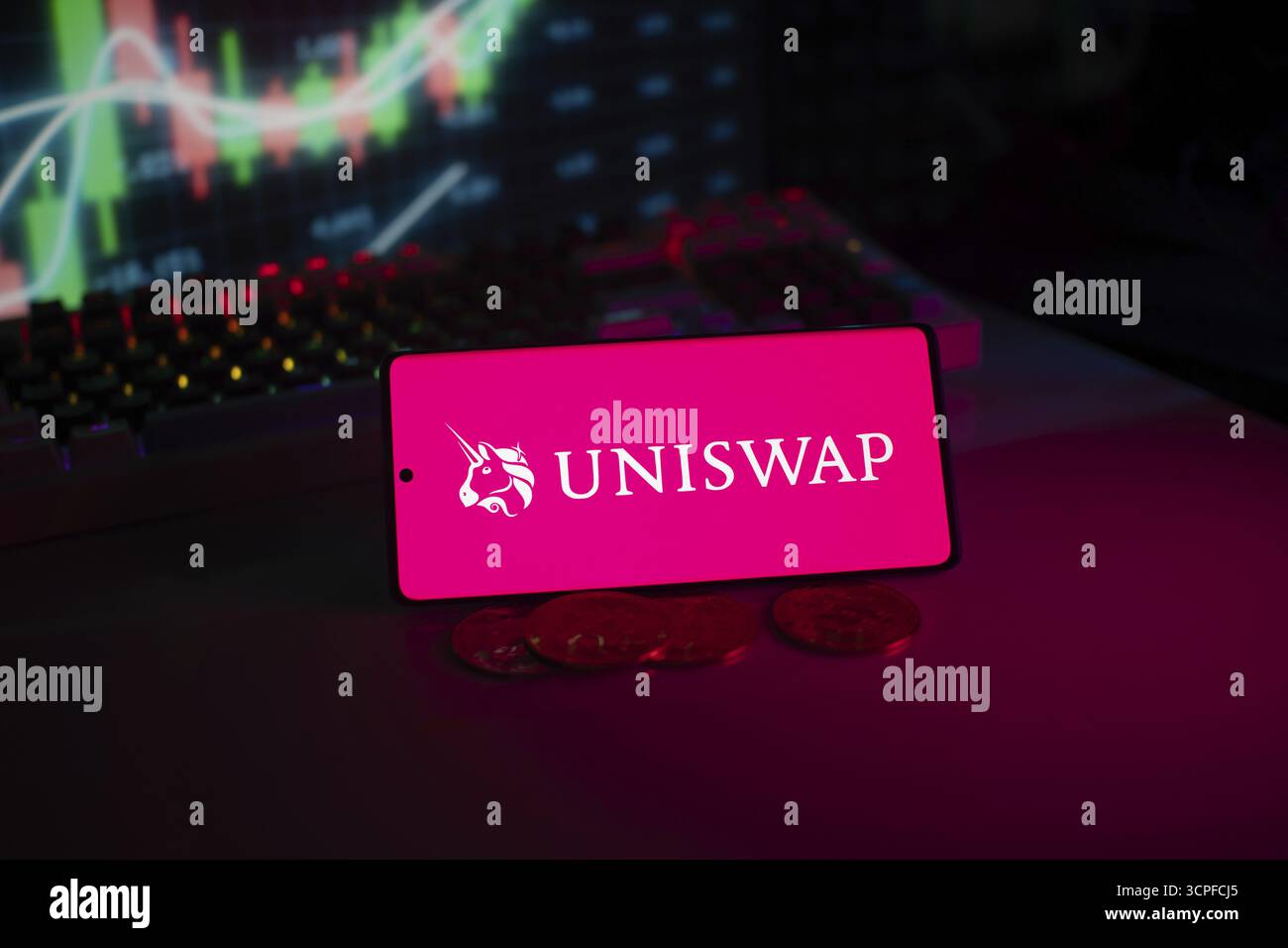 Uniswap logo on smartphone with coins and stock chart, highlighting ...
