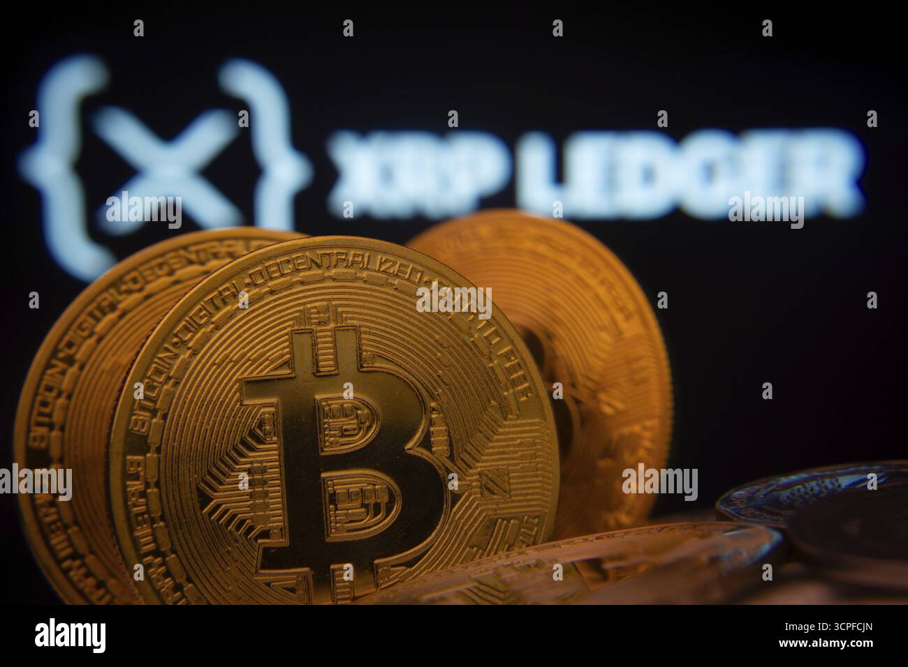 Dhaka, Bangladesh- 03 Sep 2025: Close-up of Bitcoin coins with the XRP ...
