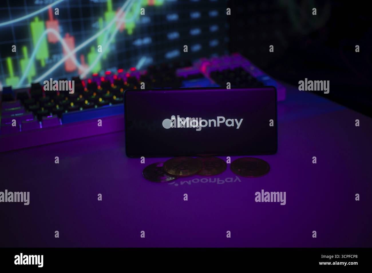 MoonPay logo on a purple screen with coins and trading graphs ...