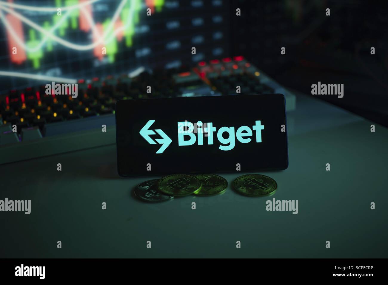 Bitget logo on black screen with coins and trading graphs in the ...