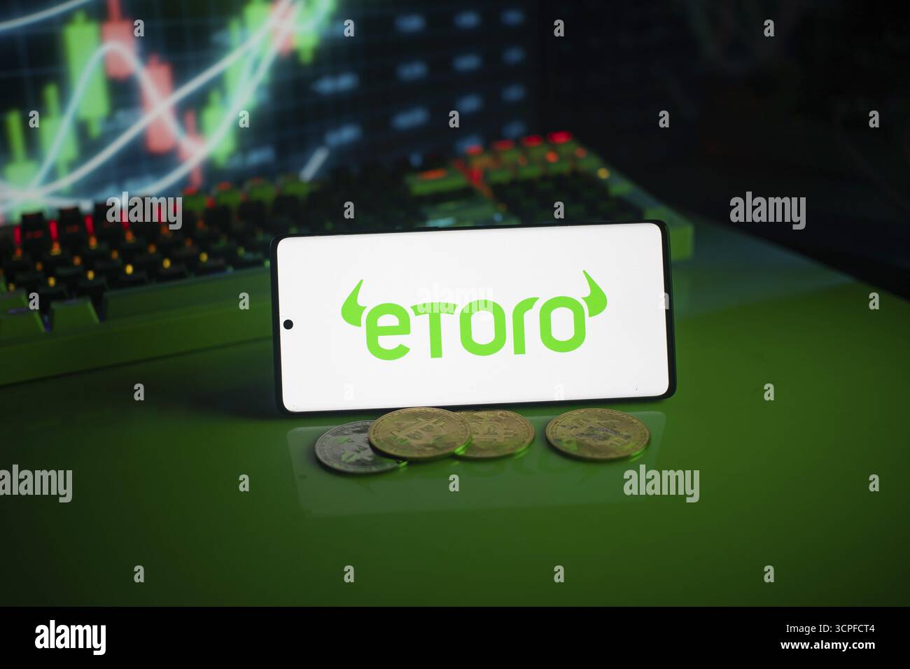 EToro logo on green screen with coins and trading graphs in the ...