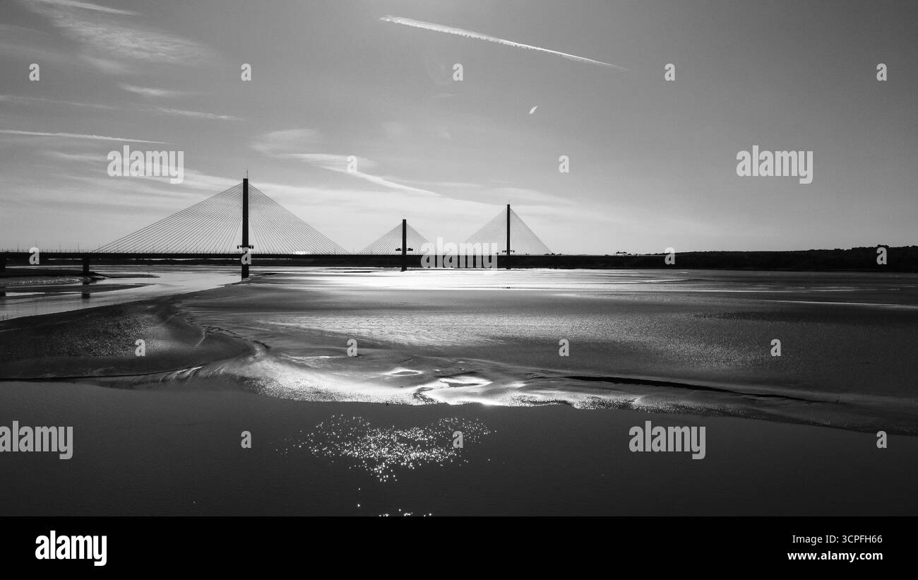 Aerial view of the Mersey Gateway Bridge over the River Mersey in black ...