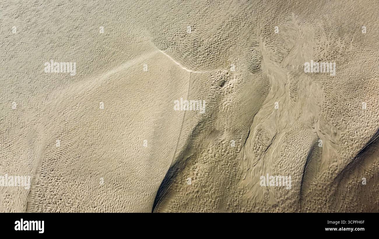 Aerial view of dried mud patterns on tidal flats in the Mersey Estuary ...