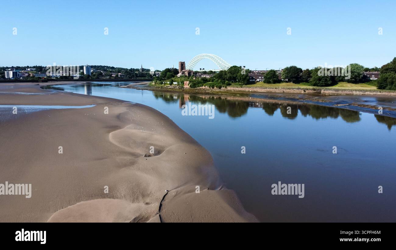 Aerial view of Runcorn Bridge and the River Mersey with tidal sandbanks ...