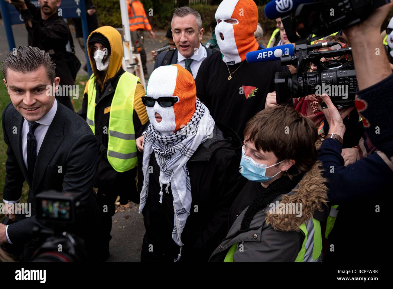 Kneecap's Liam Og O hAnnaidh (centre)with his lawyer Darragh Mackin ...