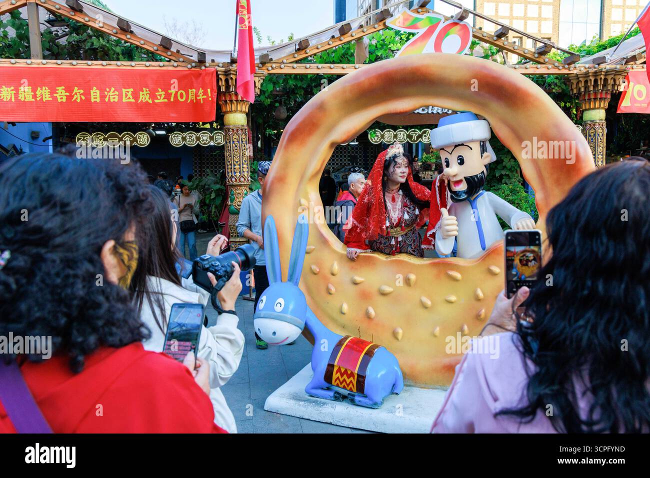 Tourists visit the Grand Bazaar in Urumqi City, northwest China's ...