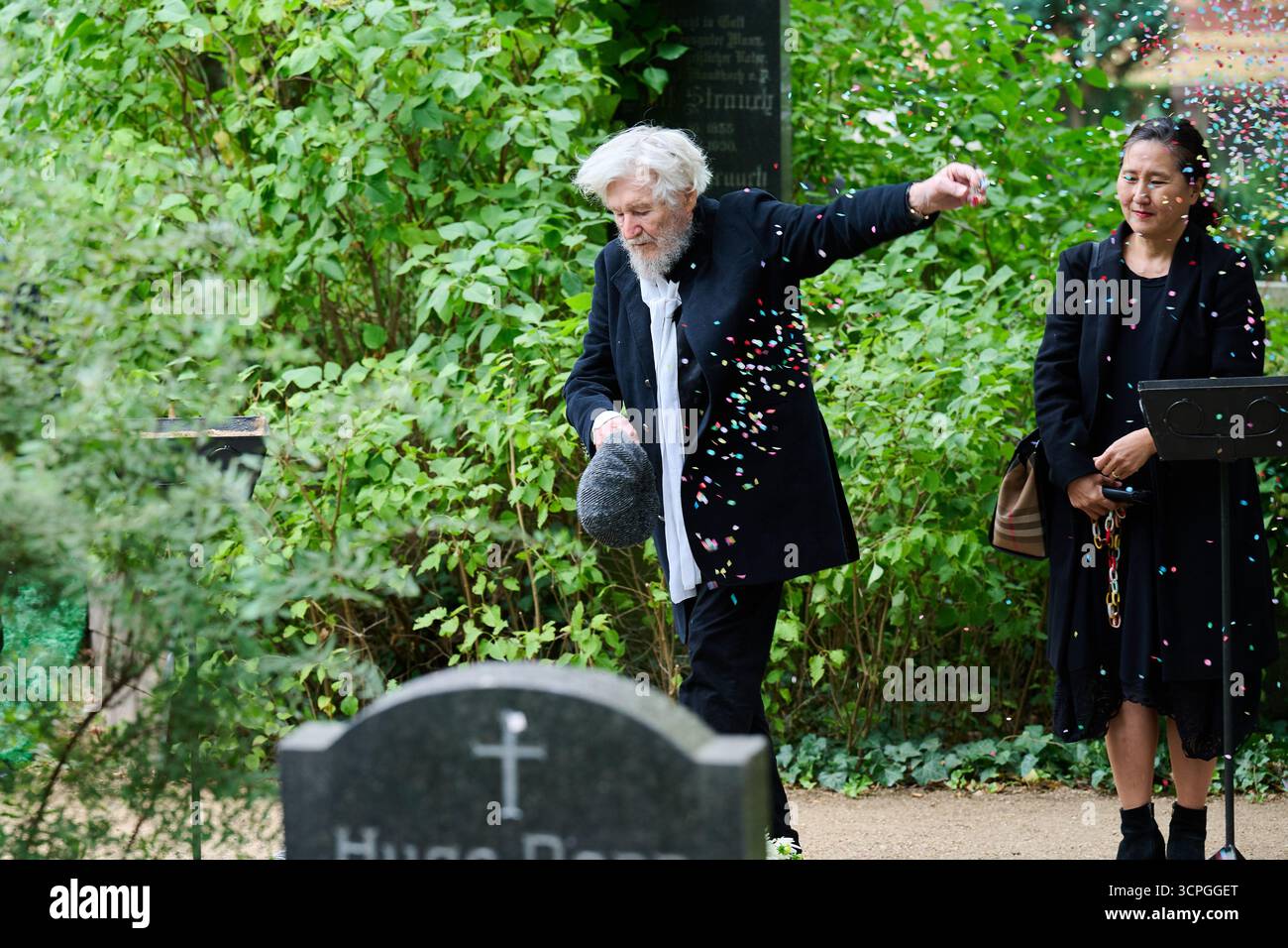26 September 2025, Berlin: Achim Freyer, director, throws confetti into ...