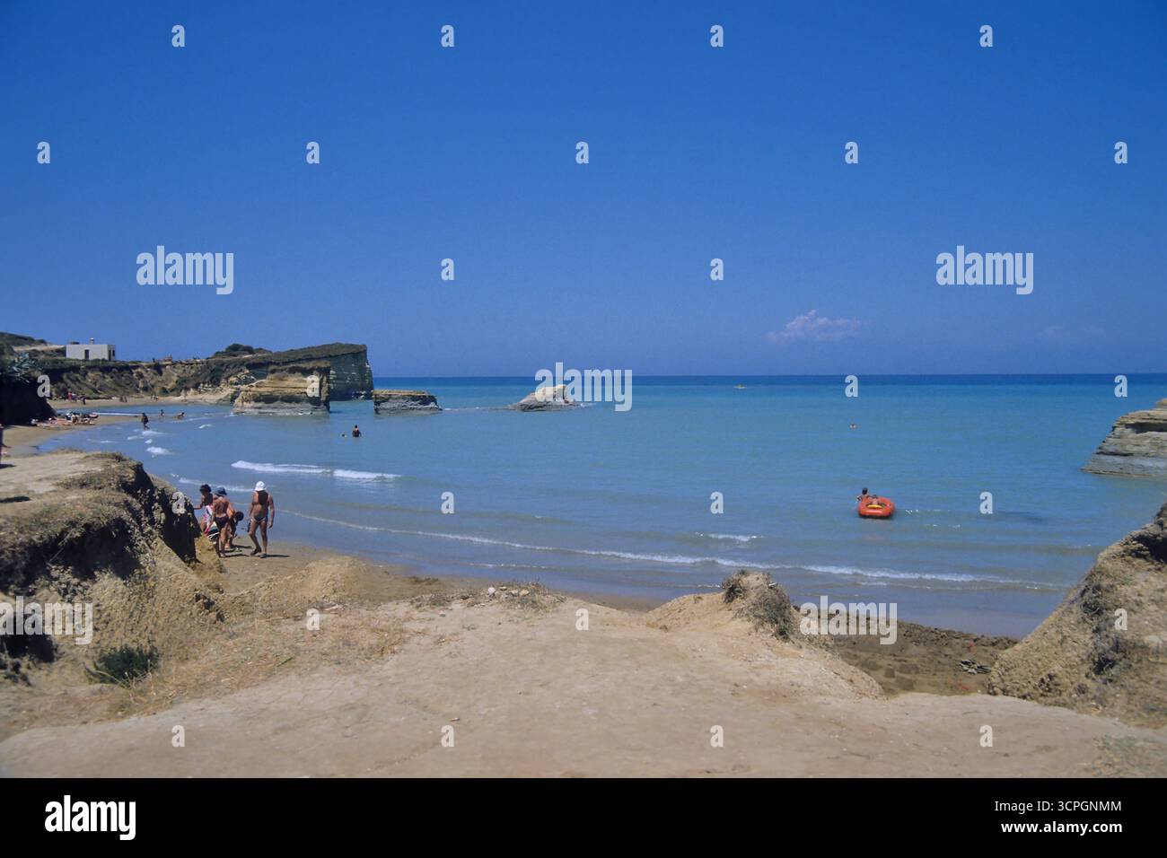 People enjoying summer 1978 vacation at Sidari beach Corfu. Beachgoers ...