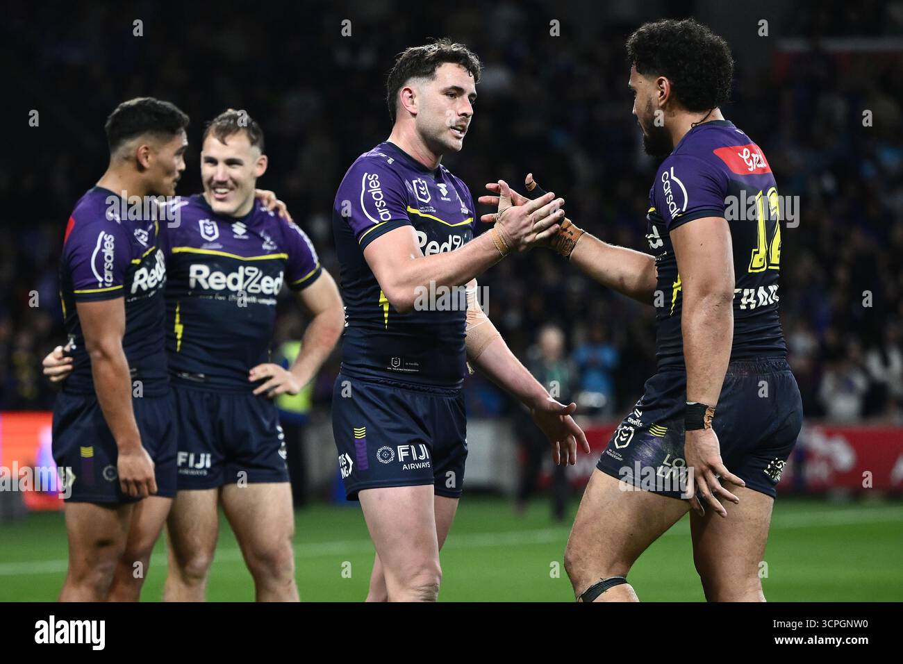 Trent Loiero of the Storm (2nd right) celebrates following the NRL ...