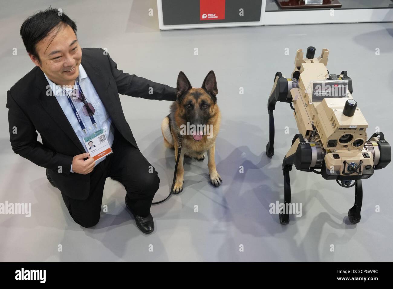 A visitor poses with a Serbian army sniffer dog and the reconnaissance ...