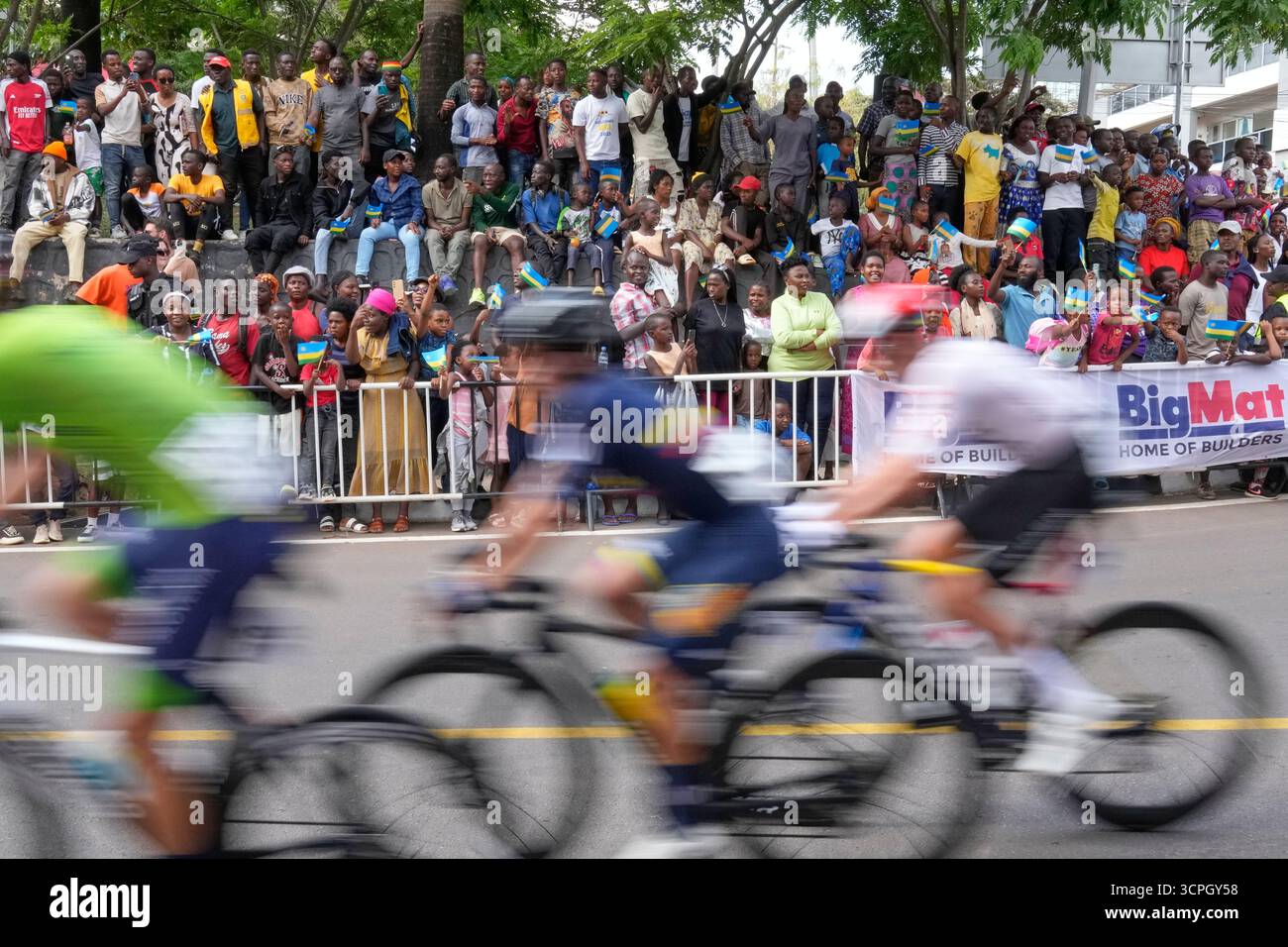Riders pedal past spectators during the men's Under 23 road race, at ...