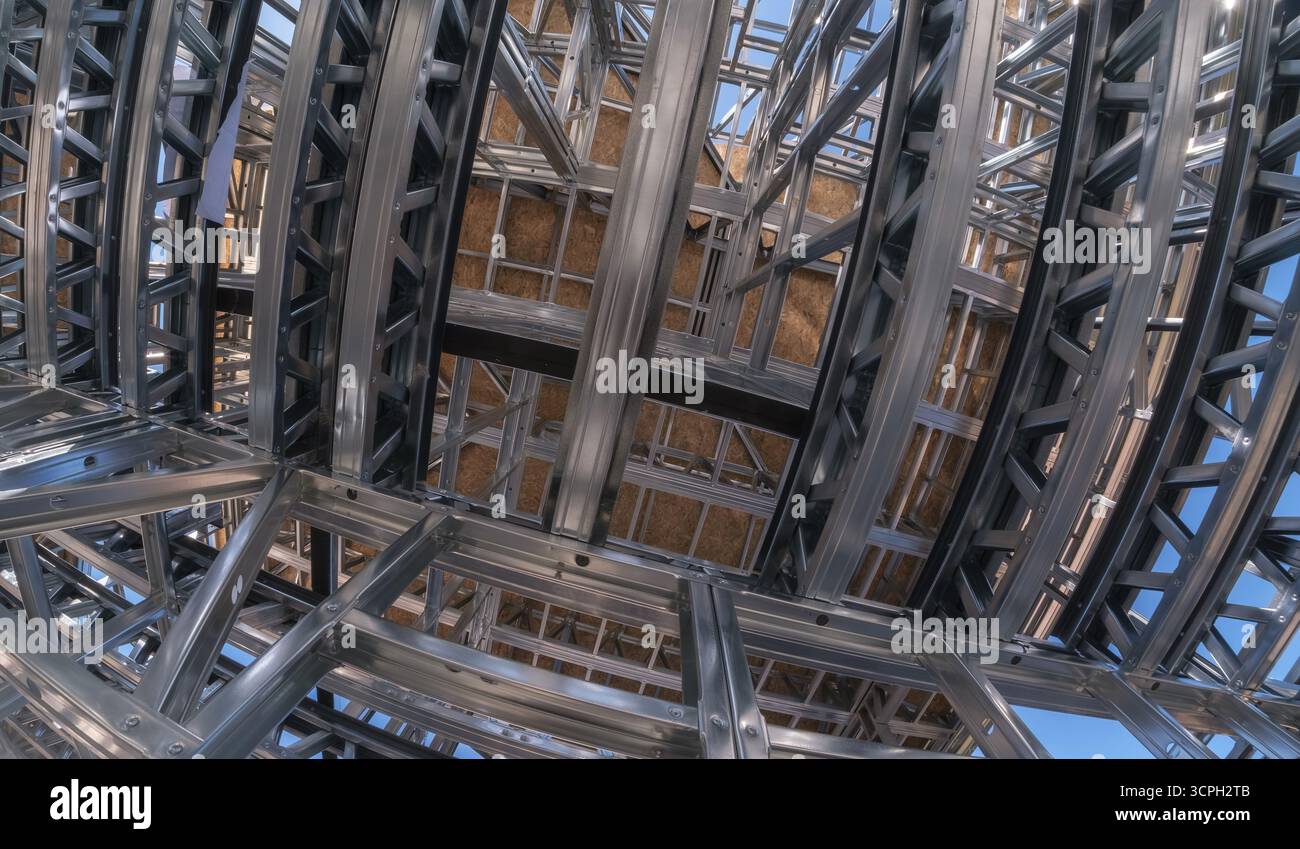 A framework of steel beams forms an industrial structure with a complex ...