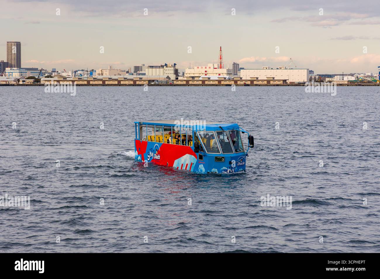 Amphibious tour bus with tourists cruising in the water of Yokohama ...