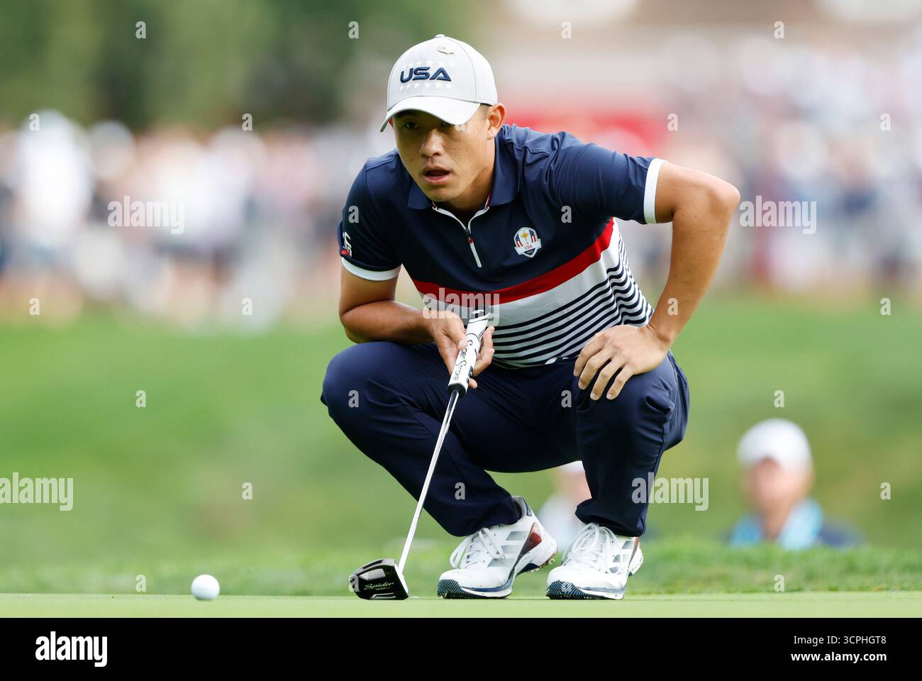 Colin Morikawa of team Unites States lines up a putt on the third hole ...