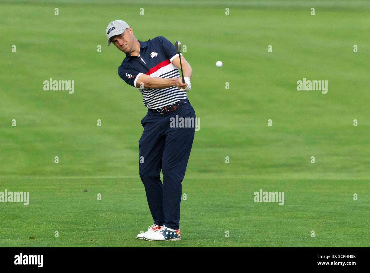 Justin Thomas of the United States Team hits a ball on the first ...