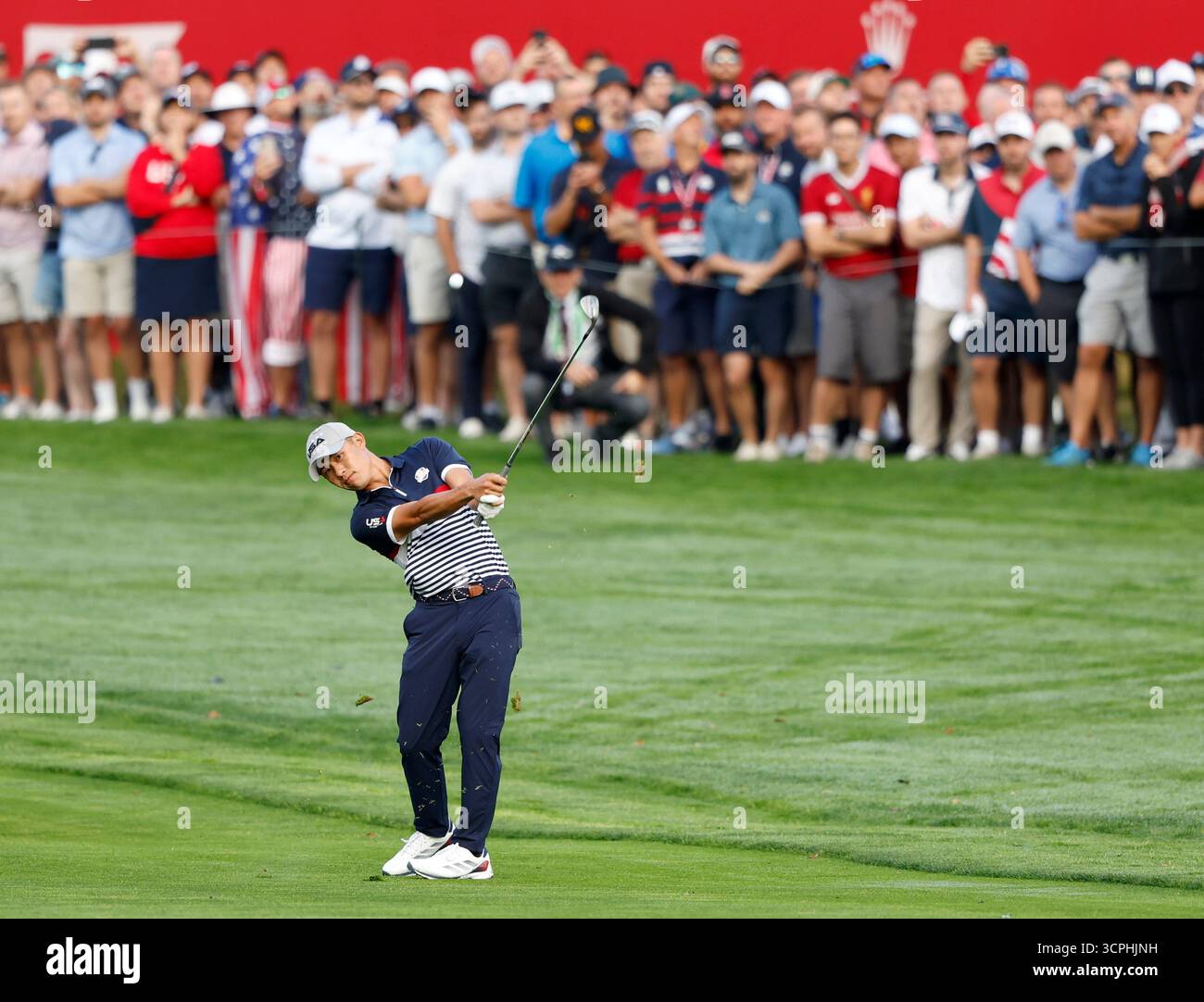 Colin Morikawa of team Unites States hits his approach shot to the ...
