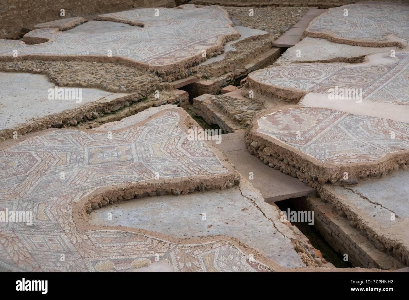 Ancient Roman mosaic floor with intricate geometric patterns and faded colors Stock Photo - Alamy
